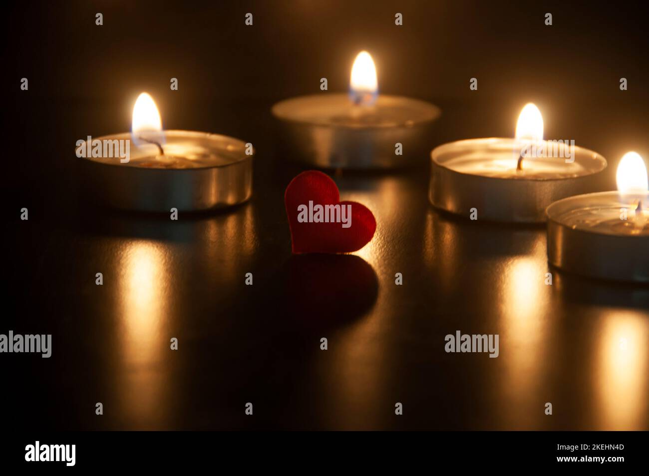 Red heart shape on dark candlelight background with customizable space ...