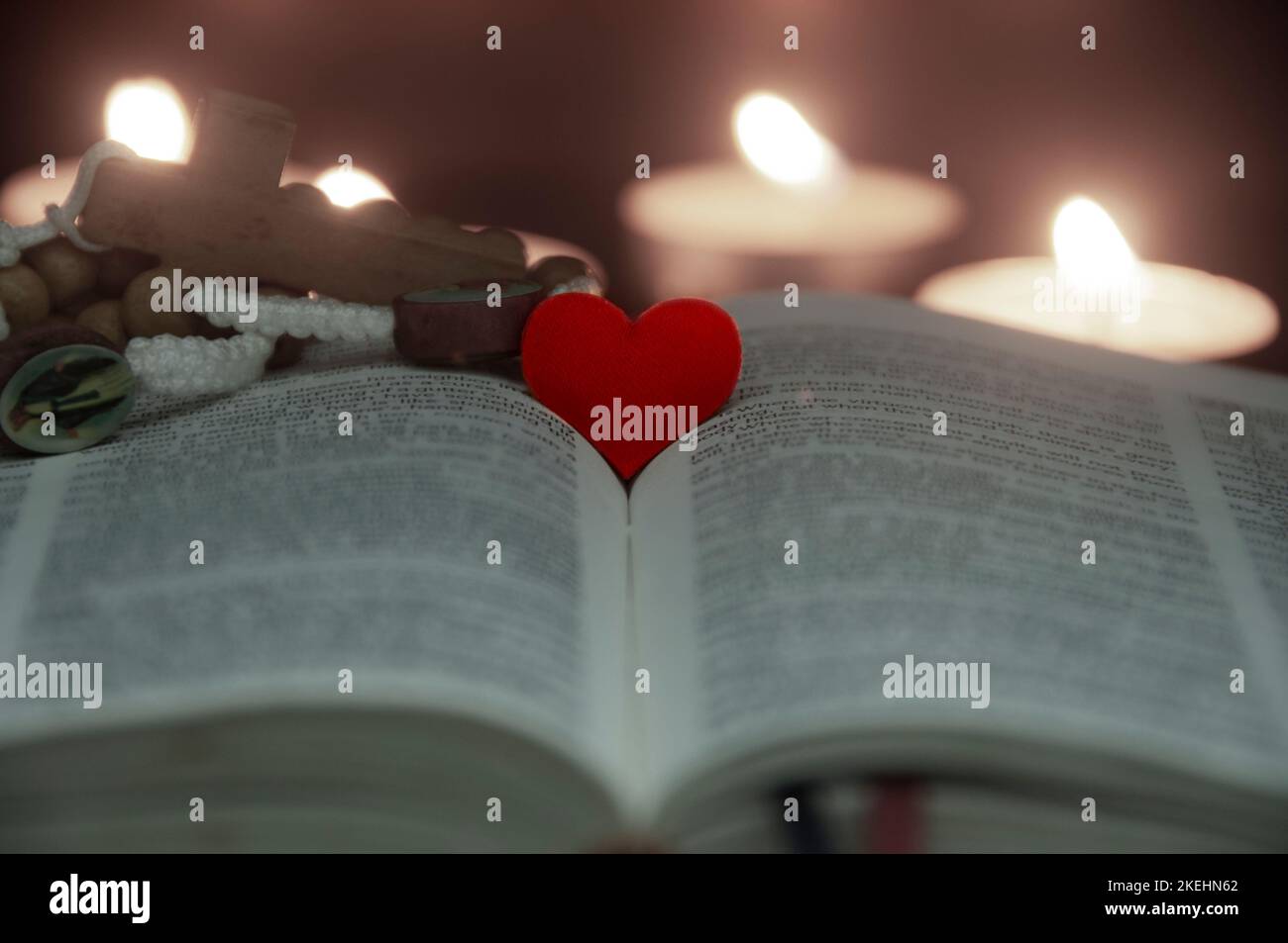 Red heart shape on Holy Bible with candle lights and vintage color ...