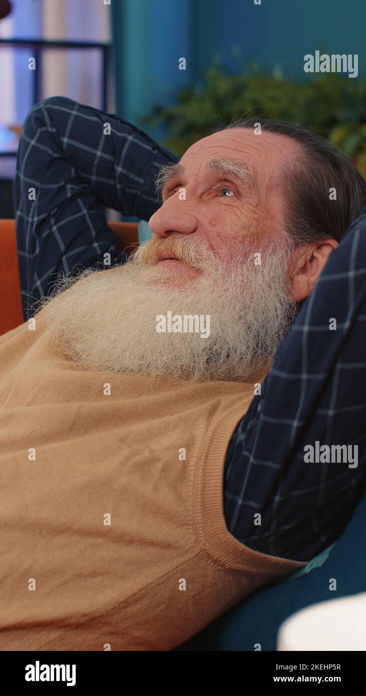 Tired one senior old man lying down in bed taking a rest at home ...