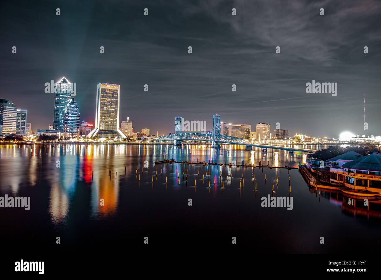 The glowing night cityscape with the Acosta Bridge spanning the Saint ...