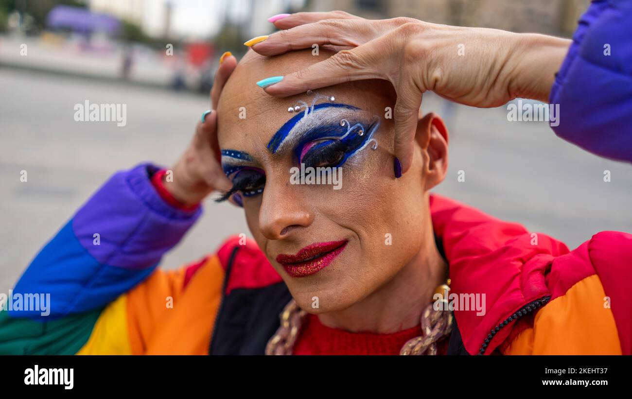Dragqueen strolls around town listening to music with her coffee cup ...