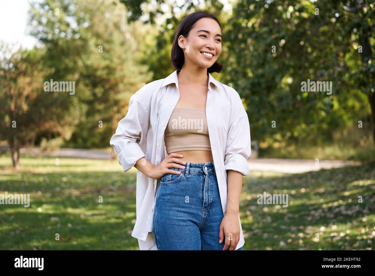 Happy asian girl walking in park, feeling freedom and joy, walking ...
