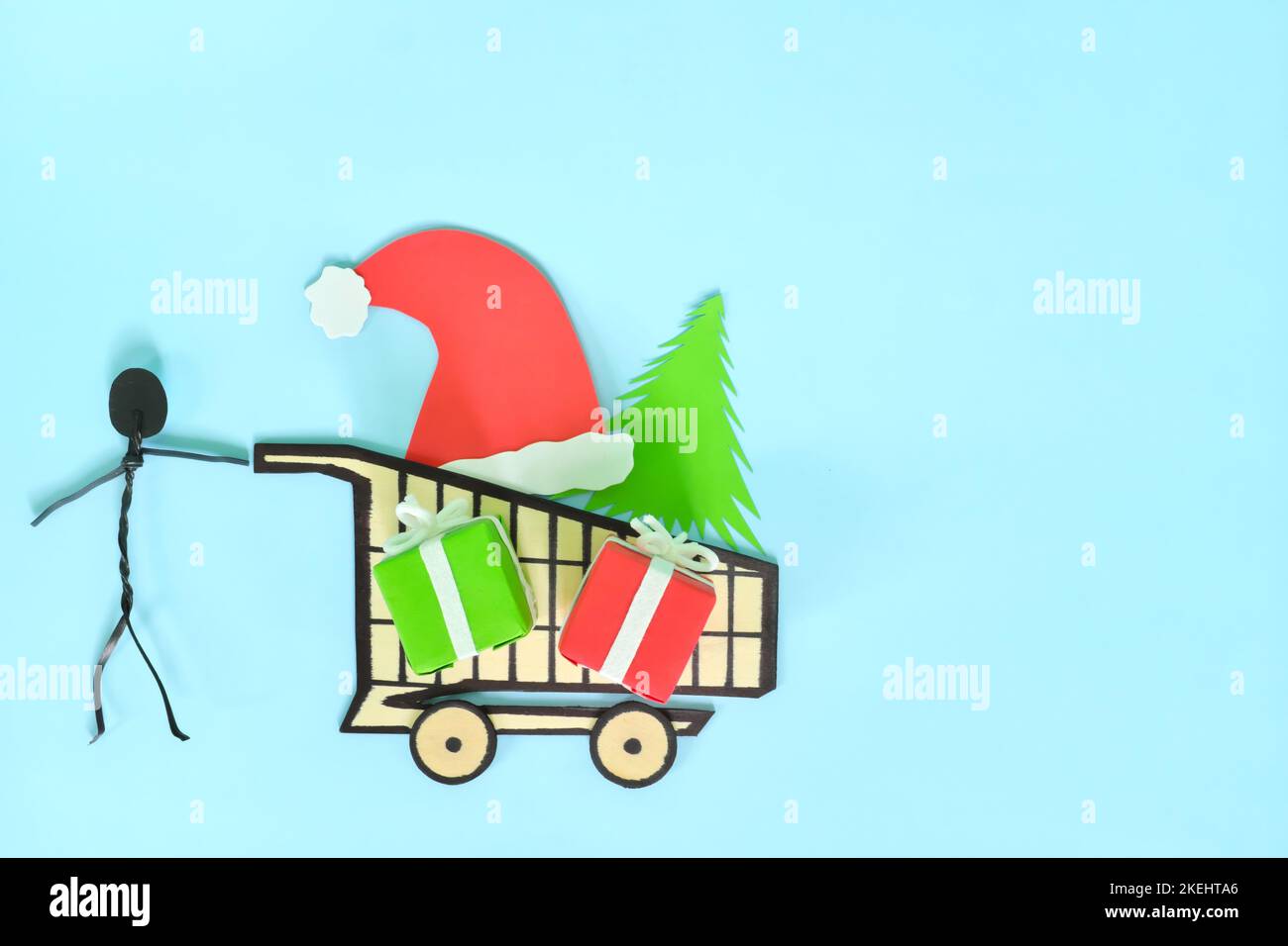 Happy Christmas shopping concept. Stick figure pushing a shopping cart ...