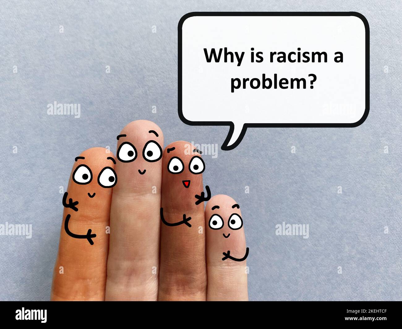 Four fingers are decorated as four person with different races. They ...