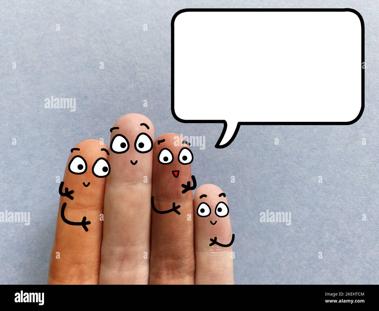 Four fingers are decorated as four person with different races. They ...