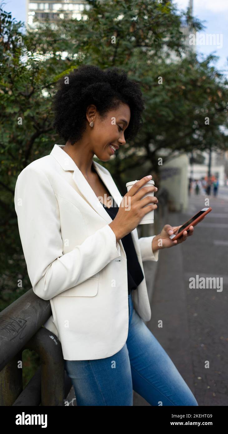 black woman uses technology during an afternoon in the city Stock Photo ...