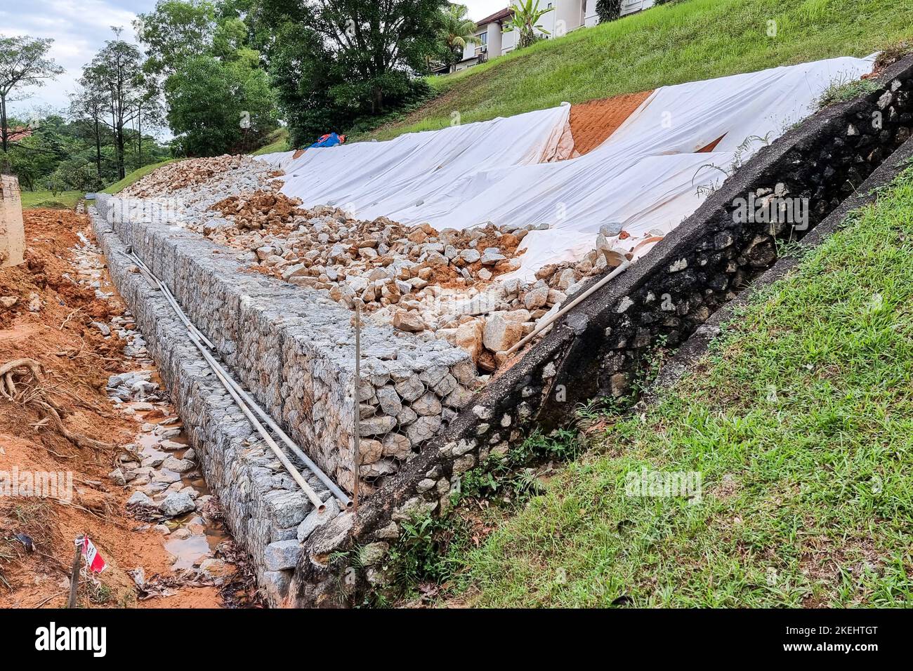 Series of slope retention construction design with rocks and mesh to ...