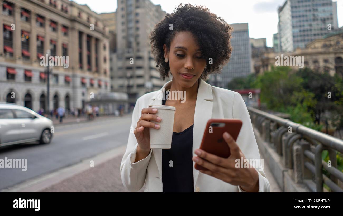 black woman uses technology during an afternoon in the city Stock Photo ...