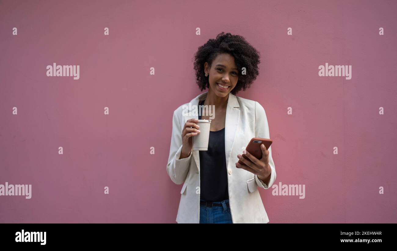 black woman uses technology during an afternoon in the city Stock Photo ...