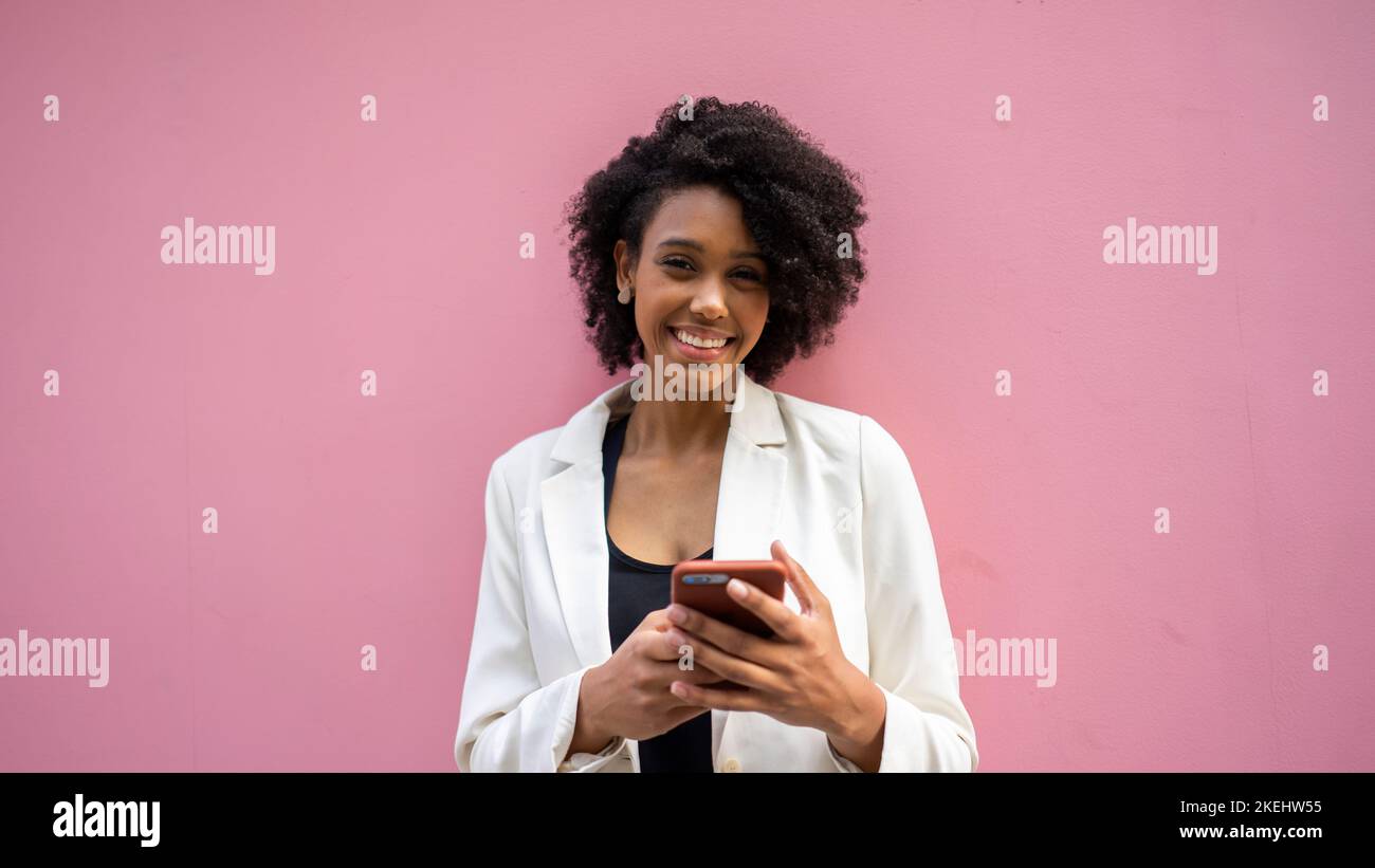black woman uses technology during an afternoon in the city Stock Photo ...