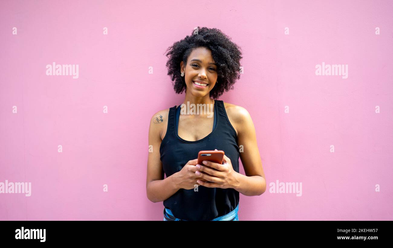 black woman uses technology during an afternoon in the city Stock Photo ...