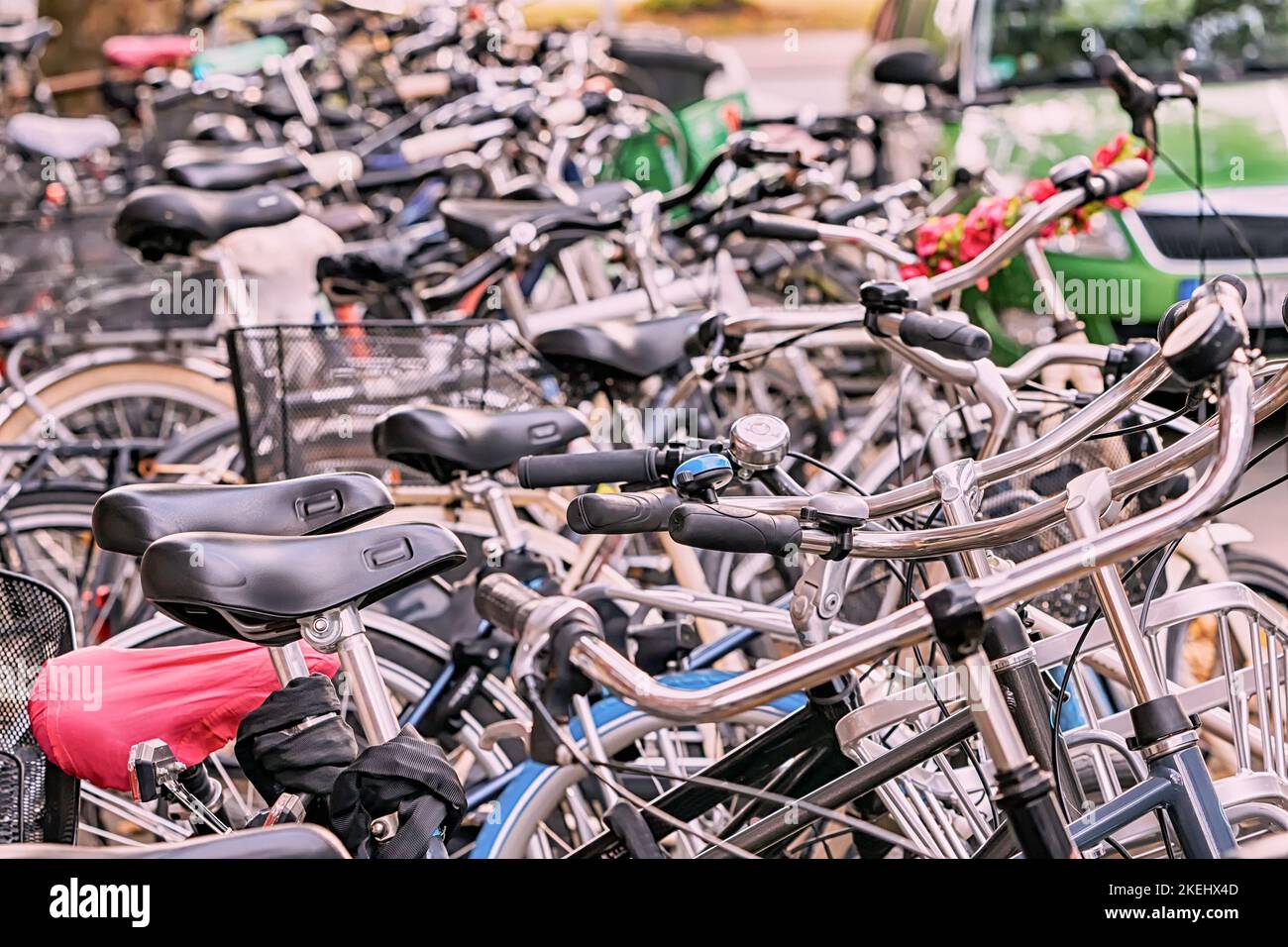 Many bicycles and bikes parked at public parking lot at city street ...