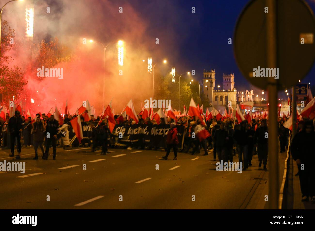 People march with flags and smoke flares during the celebration. On ...