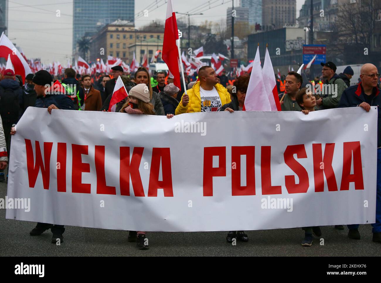 People march with flags and a banner expressing their opinion during ...