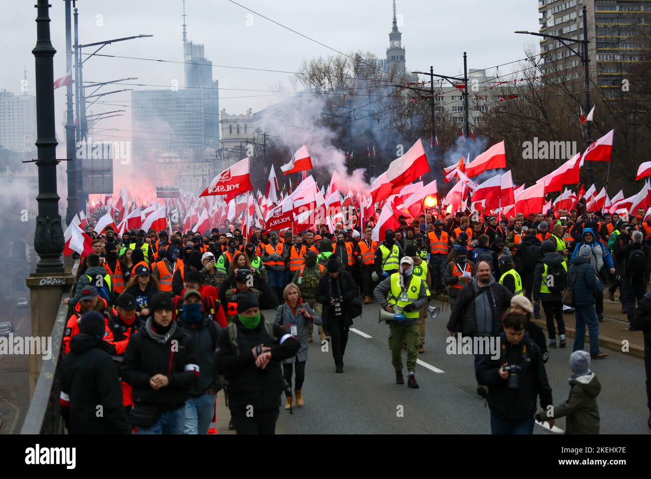 People march with flags and smoke flares during the celebration. On ...