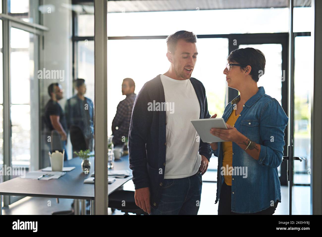 Prepping for the meeting. a two colleagues having a conversation before ...
