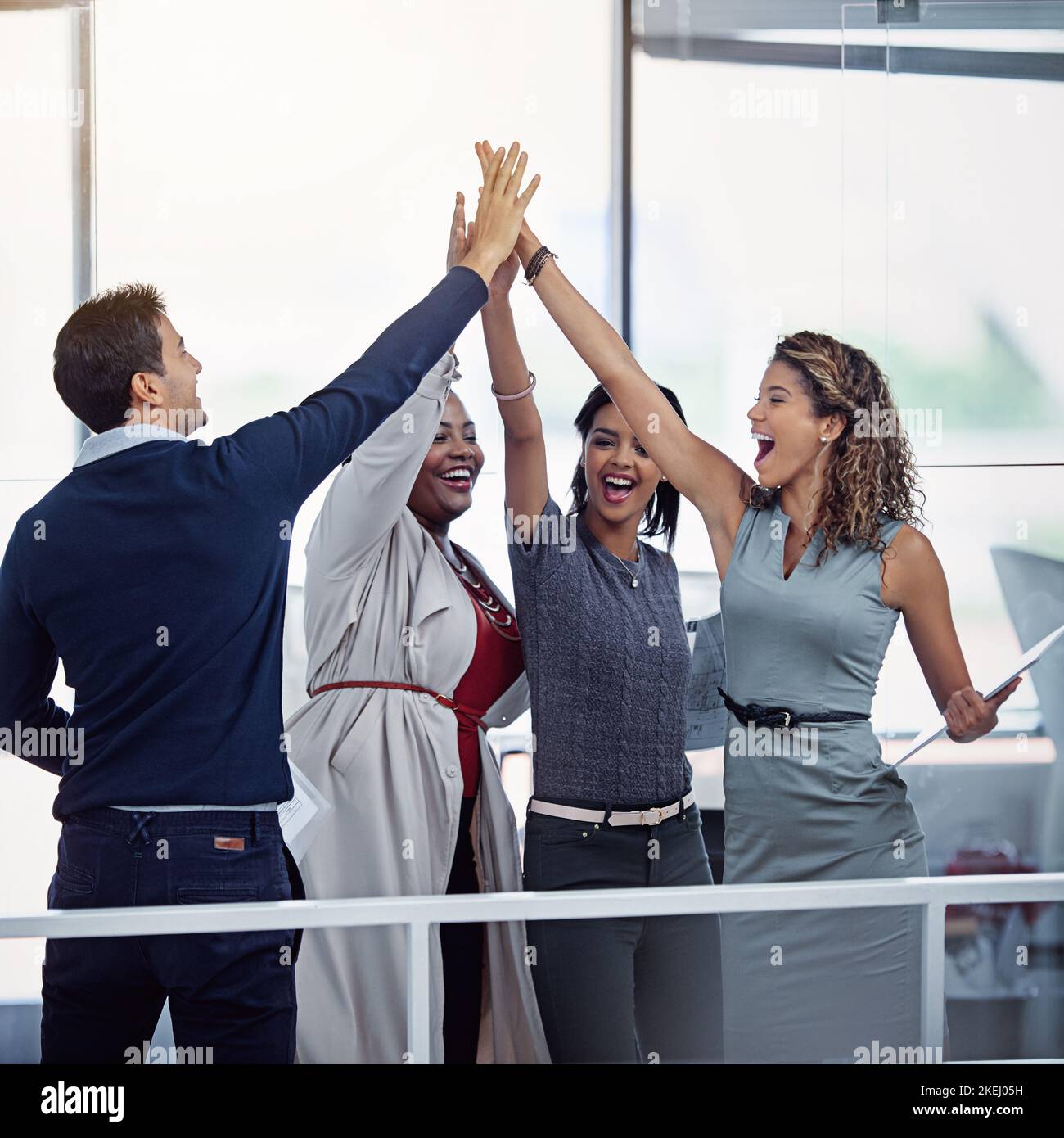 Professional colleagues high fiving hi-res stock photography and images ...