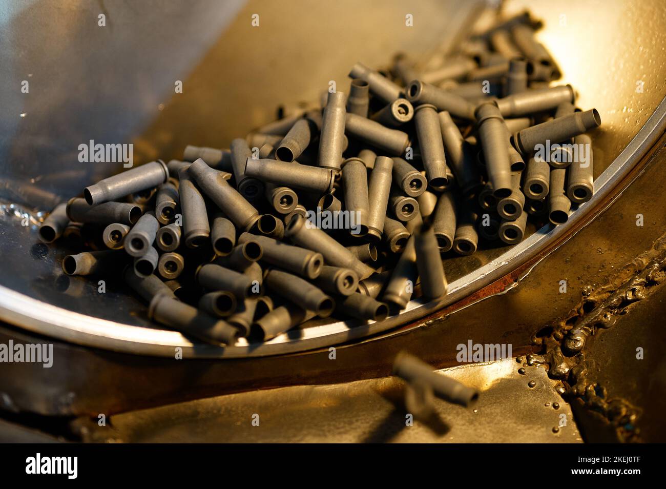 Shell casings fall down in ammunition production workshop Stock Photo ...