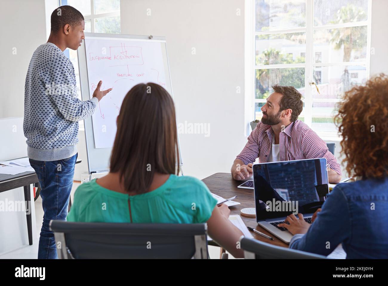 Explaining everything in detail. a young businessman giving a ...