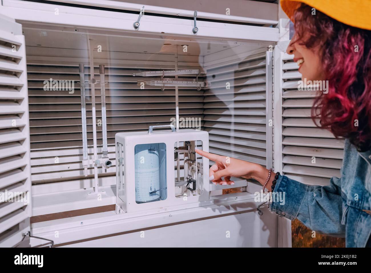 Museum visitor exploring weather station with barometer, thermometer ...
