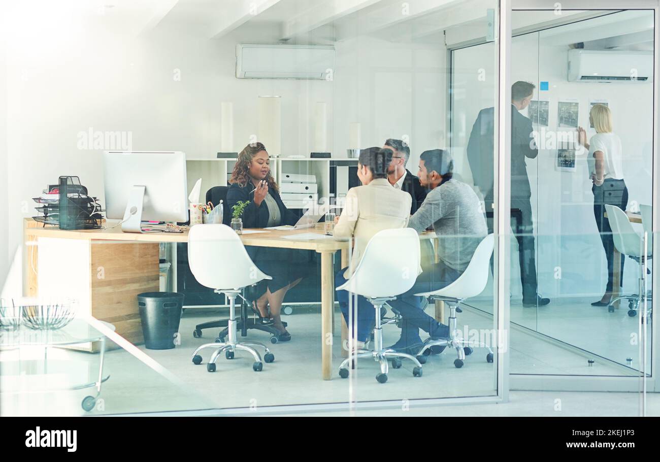 Meetings keep things on track. a group of corporate colleagues sitting ...