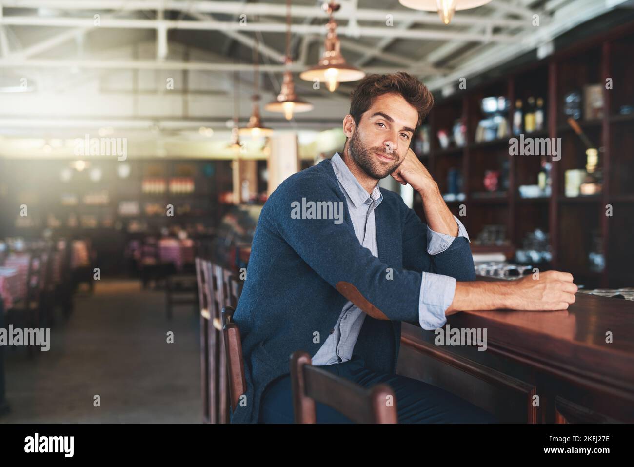 Chilling in my favourite bar. Cropped portrait of a handsome young man ...