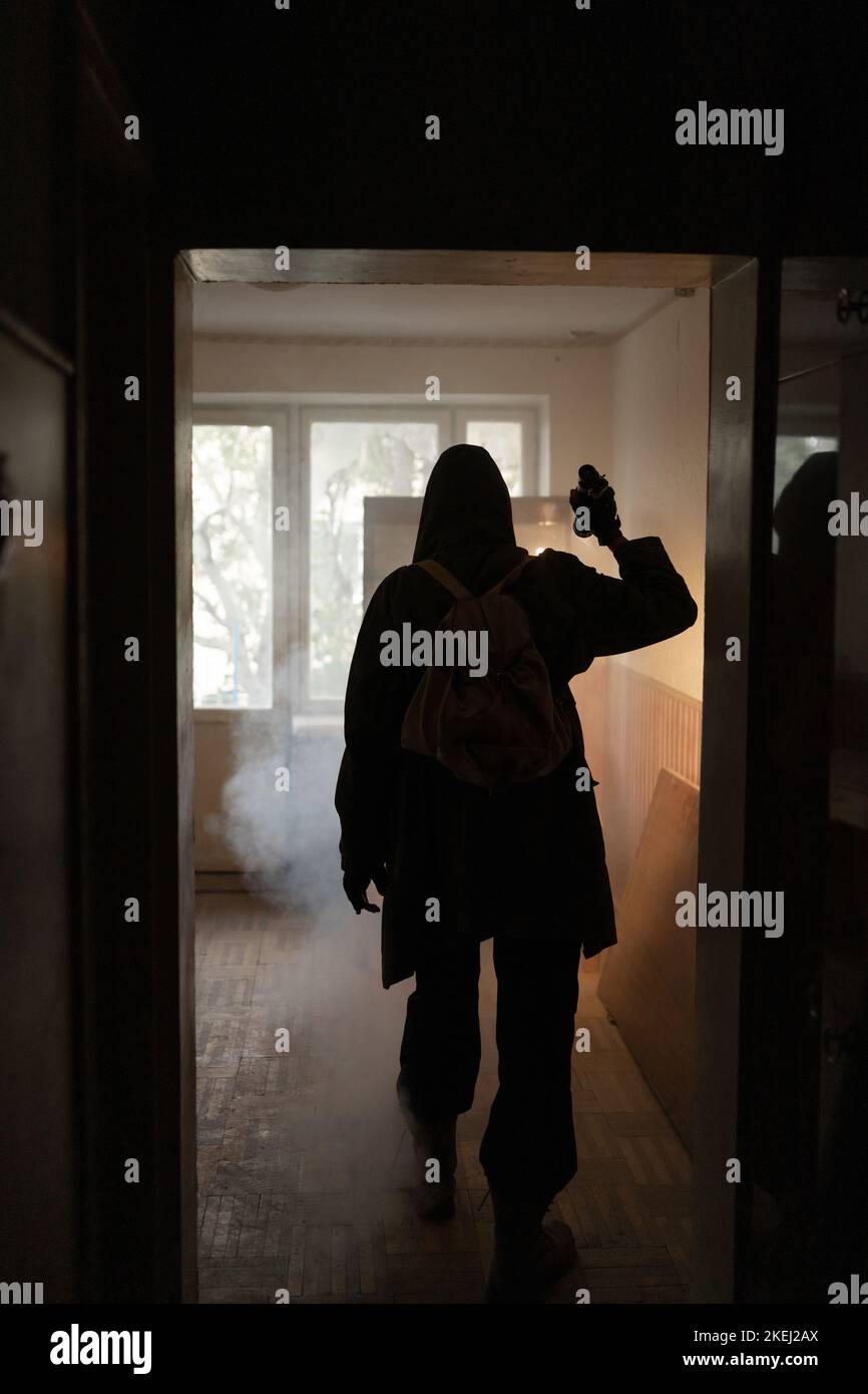 woman against the background of a window in a ruined house and shining ...