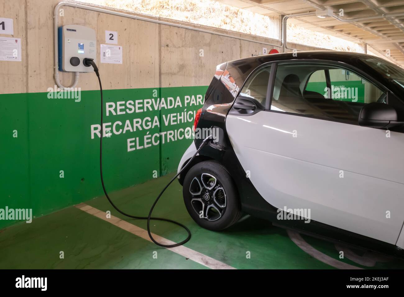 A closeup shot of a small size car charging its batteries in a public ...