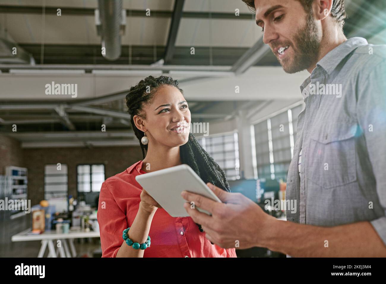 Sharing some invaluable ideas. two colleagues using a digital tablet ...