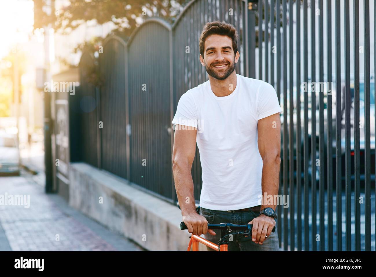 The best way to get around the city. a handsome young man riding his ...