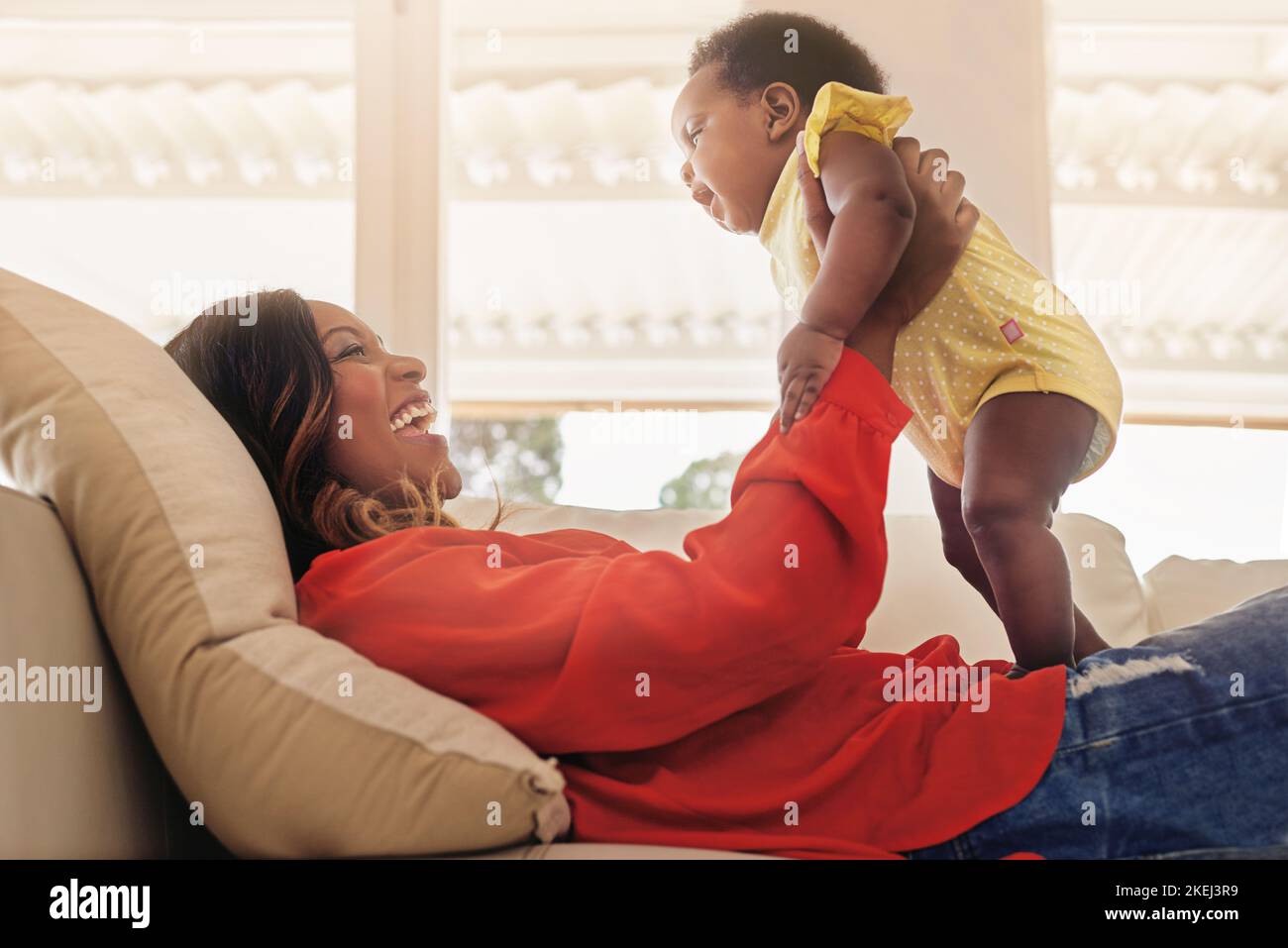 Being mother is the most fun I ever had. a mother holding up her baby ...