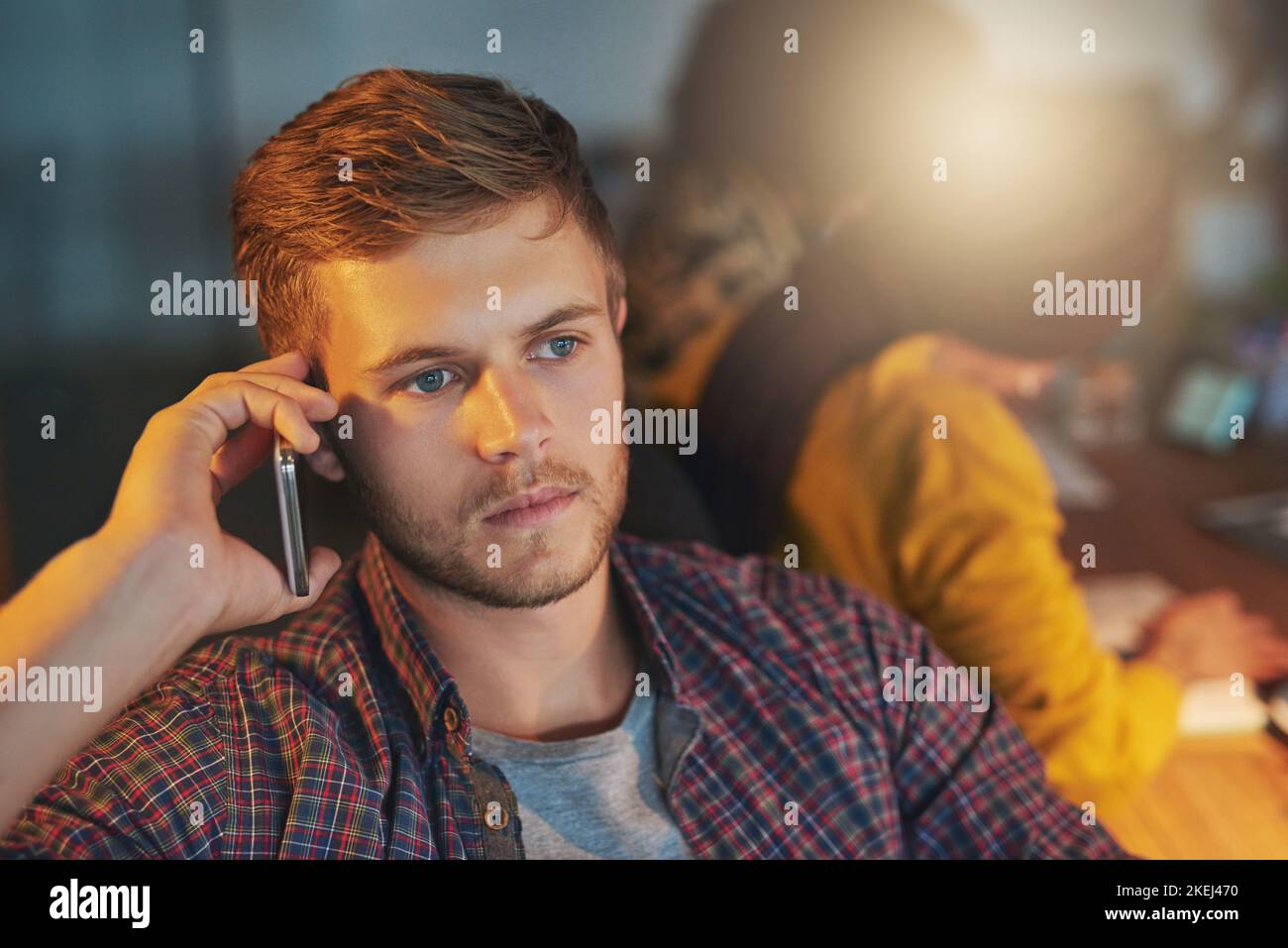 Ill handle it myself. a young man using his cellphone while working ...