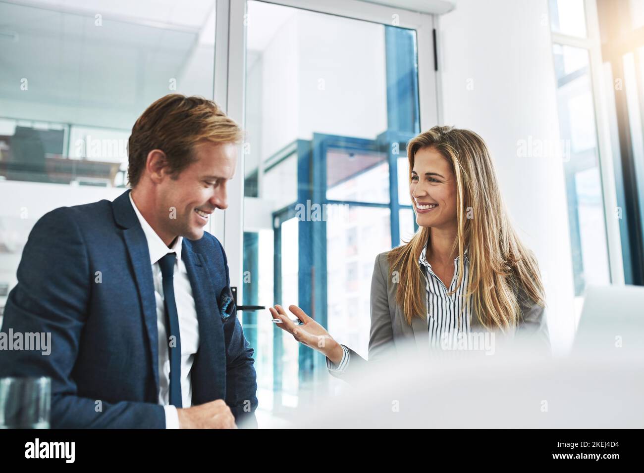 They make great things happen. two businesspeople having a discussion ...