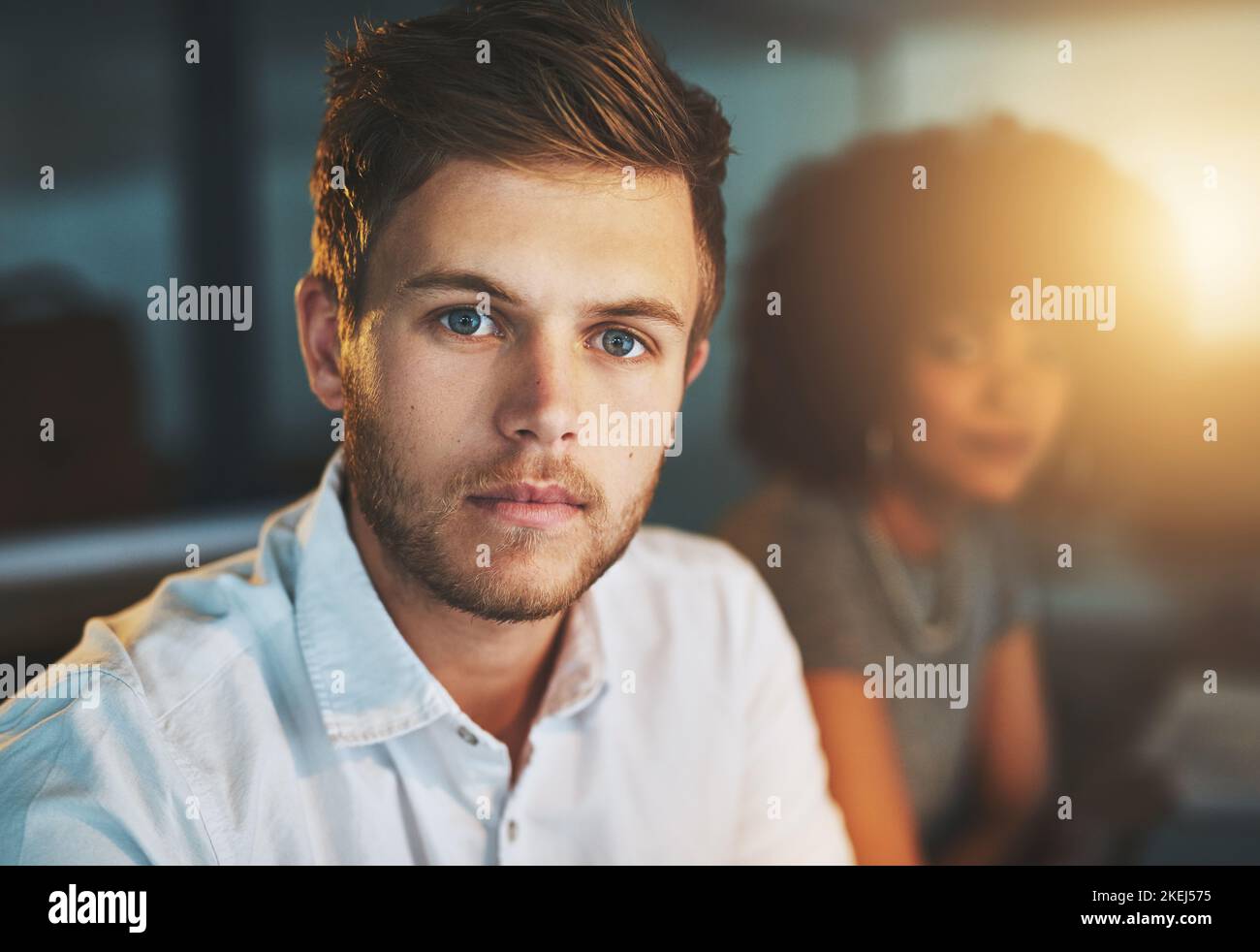 Determined to get the work done. a young designer working late at the ...