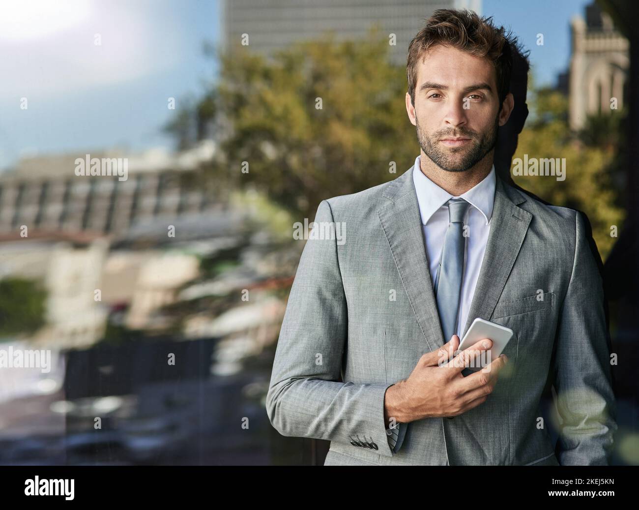 Leaning against wall man suit hi-res stock photography and images - Alamy