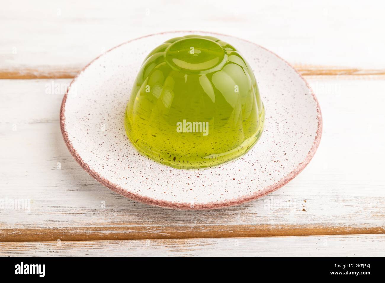 Mint green jelly on white wooden background. side view, close up Stock ...