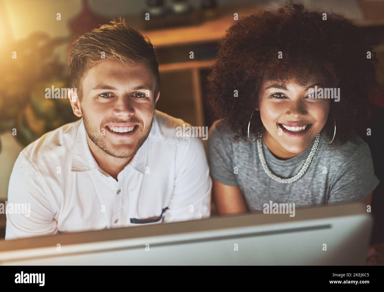 Putting our heads together. two young designers working together on a computer while looking at ...