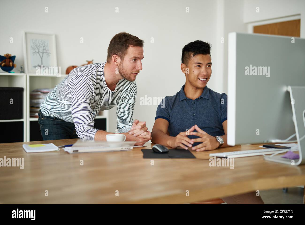 Positive and productive. two designers working together on a project in ...