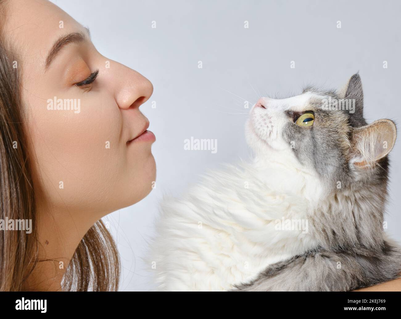 Closeup portrait handsome young woman, hugs his cat on white background ...