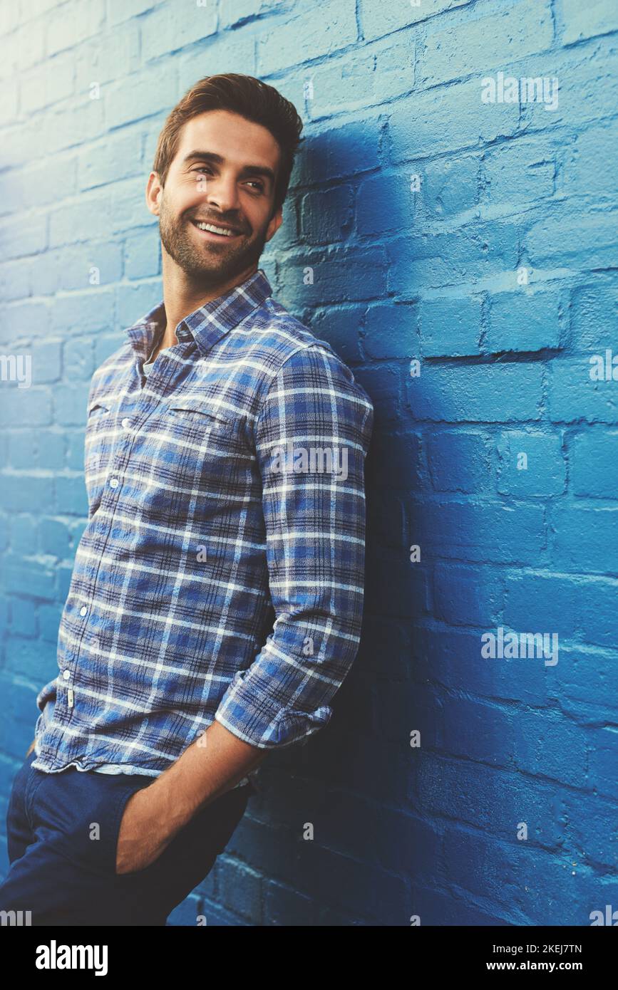 Im wearing a smile all day, everyday. a handsome young man posing ...