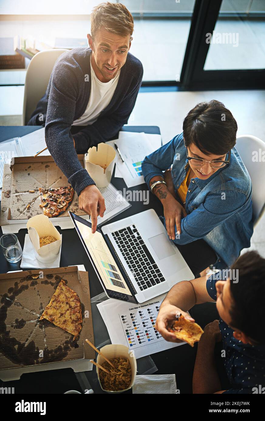 Tell me more about this...a group of colleagues eating while having a ...
