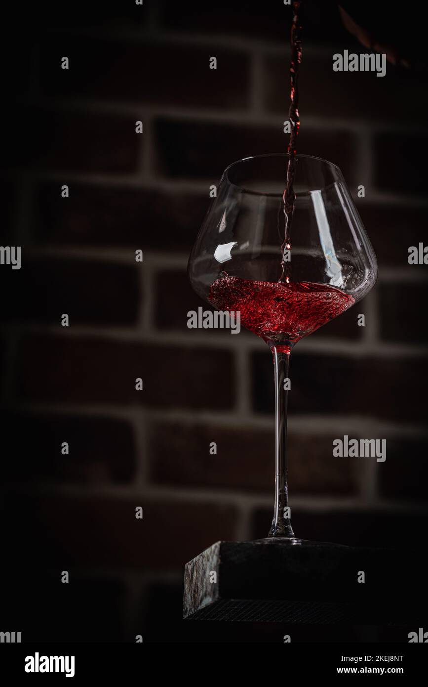Pouring red wine Stock Photo - Alamy