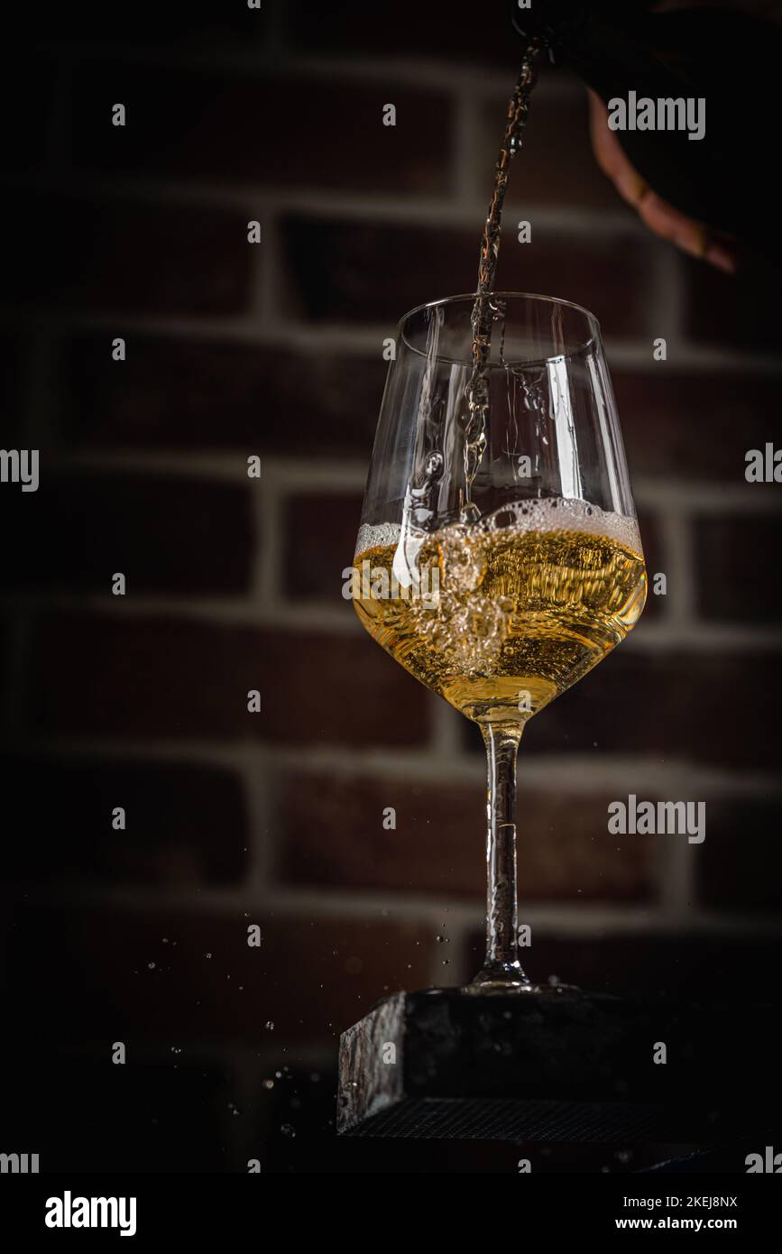 Pouring white wine Stock Photo - Alamy