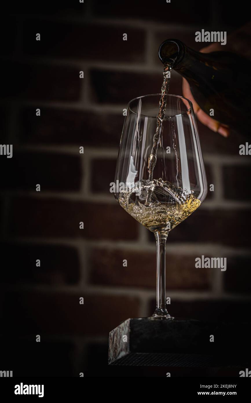 Pouring white wine Stock Photo - Alamy