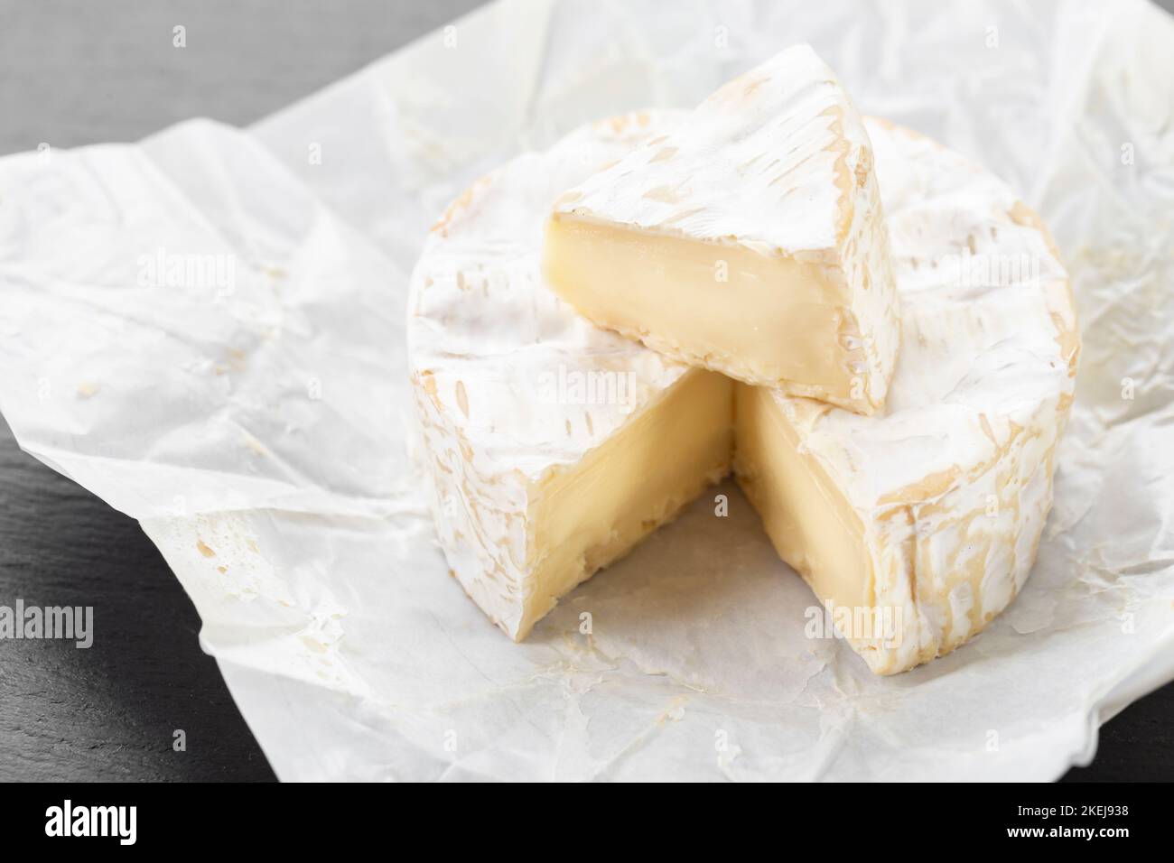 Brie type of cheese. Close up on Camember cheese. Pieces of soft cheese ...