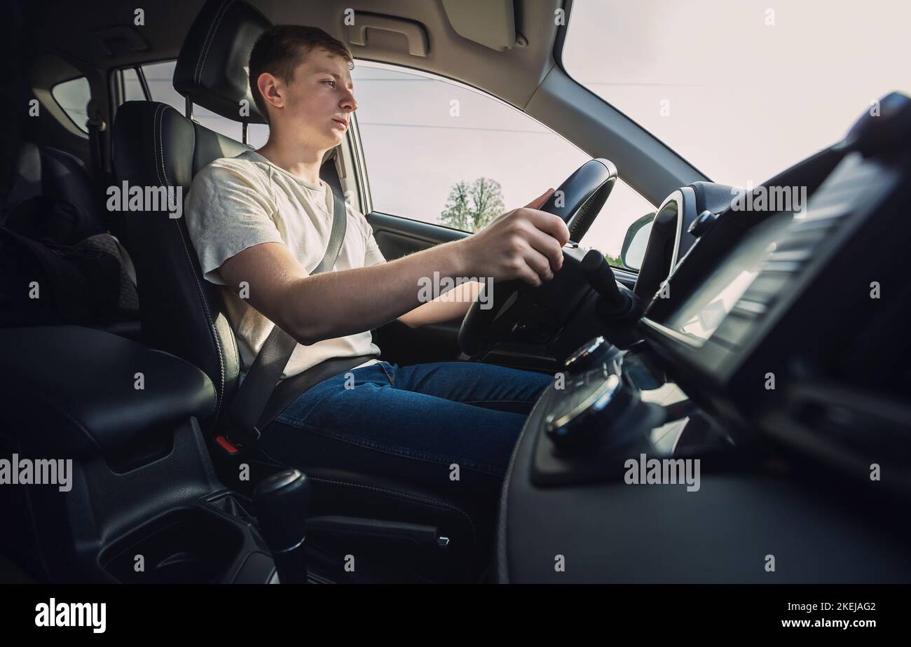 Focused young man driving car confident. Teenager driver respecting the ...