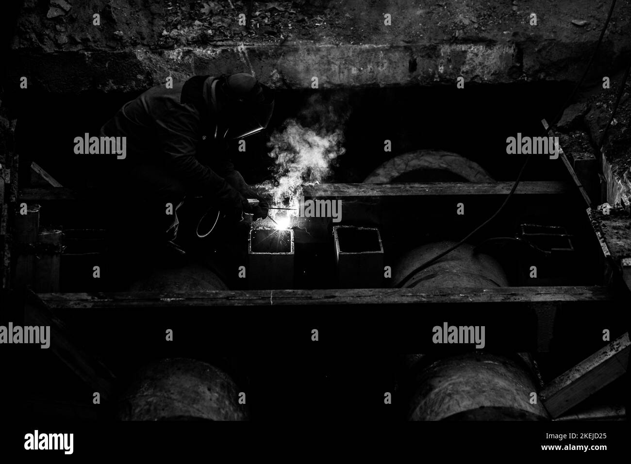 Details with a professional welder welding an industrial metallic ...