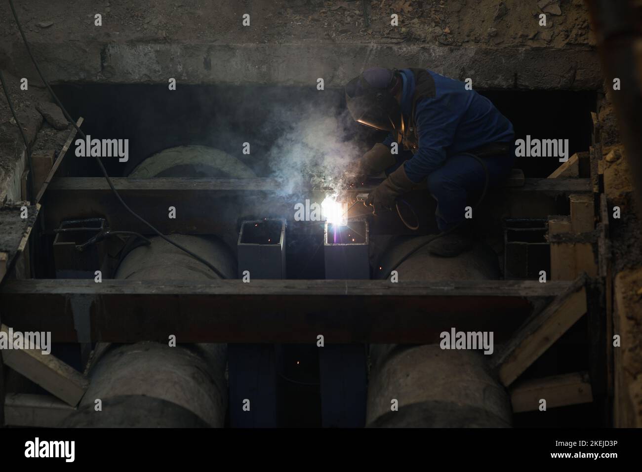 Details with a professional welder welding an industrial metallic ...