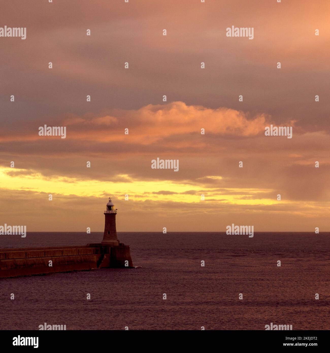 A beautiful shot of a sunrise over a lighthouse overlooking the North ...