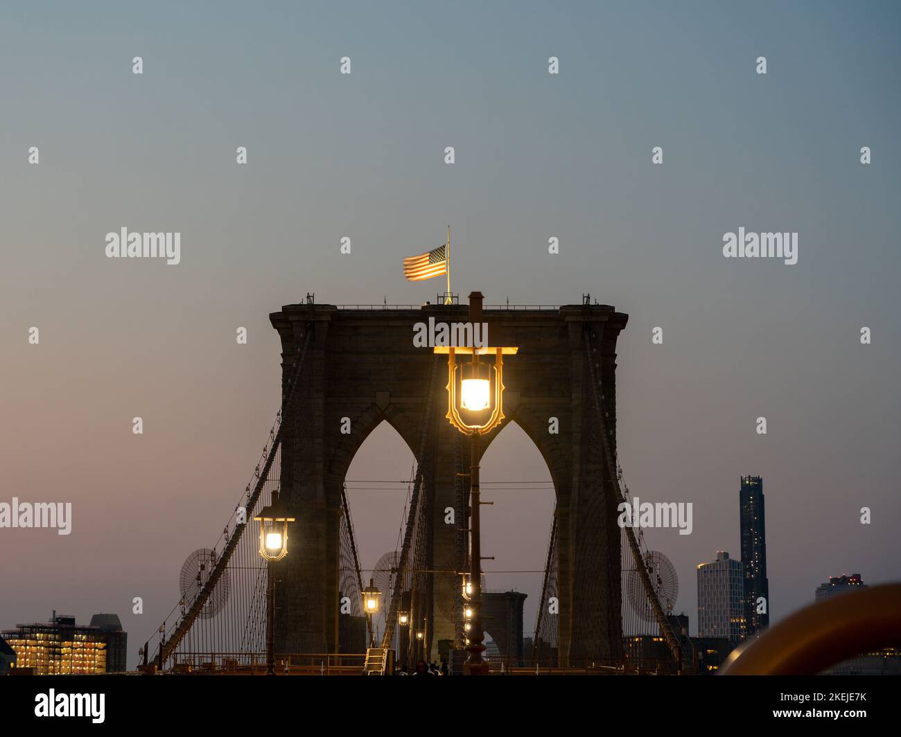 Famous arch of Brooklyn Bridge with national flag before sunrise Stock ...